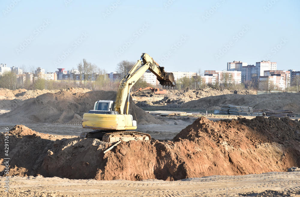 Excavator dig trench at construction site. Digging the pit foundation ...