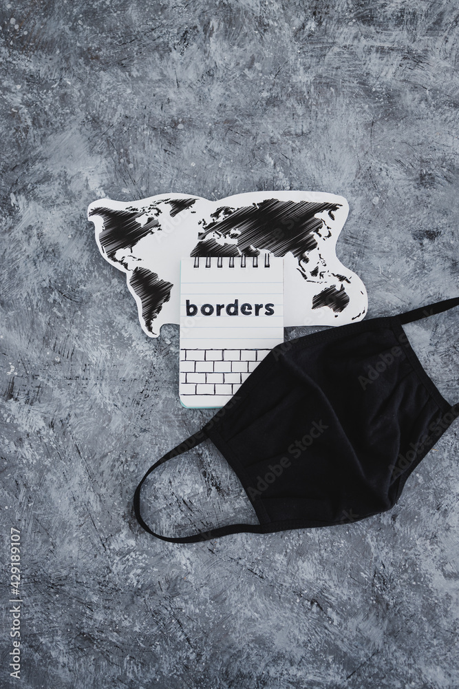 world map with face mask on it next to Borders text, travel industry ...