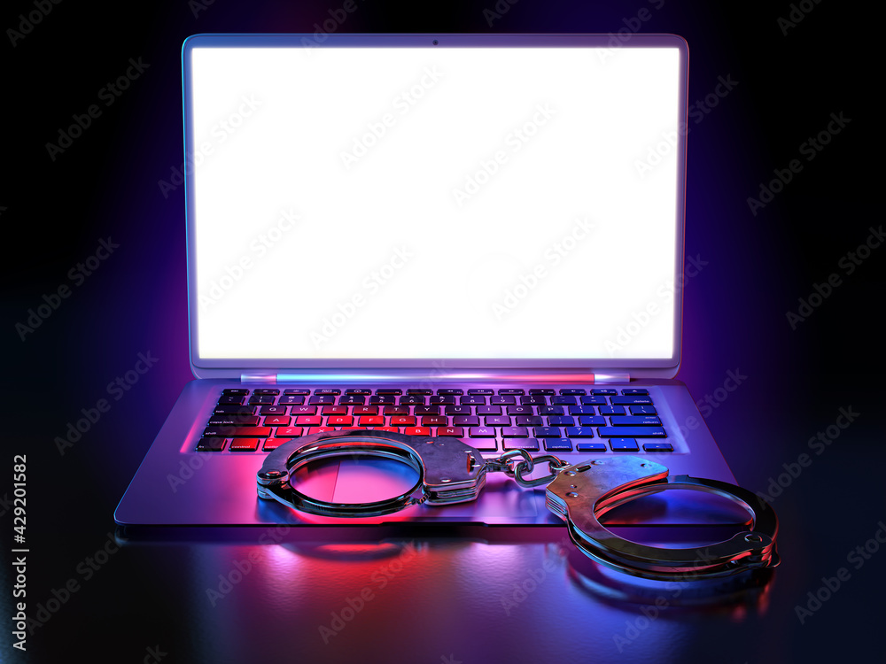 Metal handcuffs on laptop computer keyboard, blank screen template ...