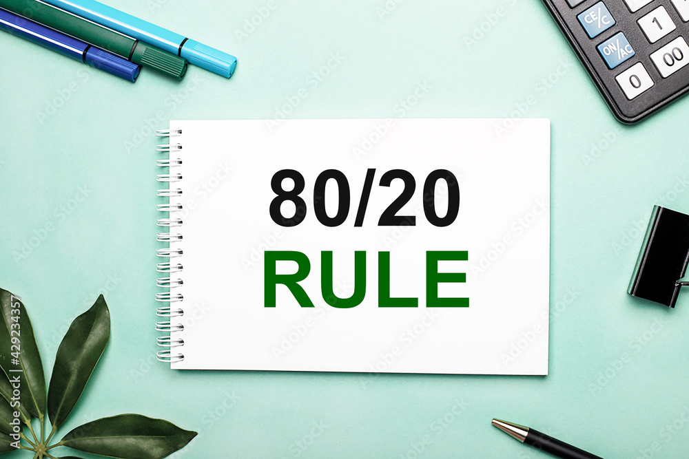 80 20 RULE is written on a white sheet on a blue background near the ...