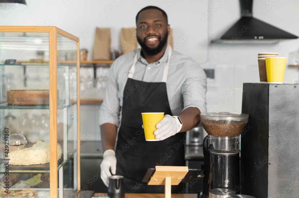 Glad African-American waiter, bakery owner, manager giving cup of ...