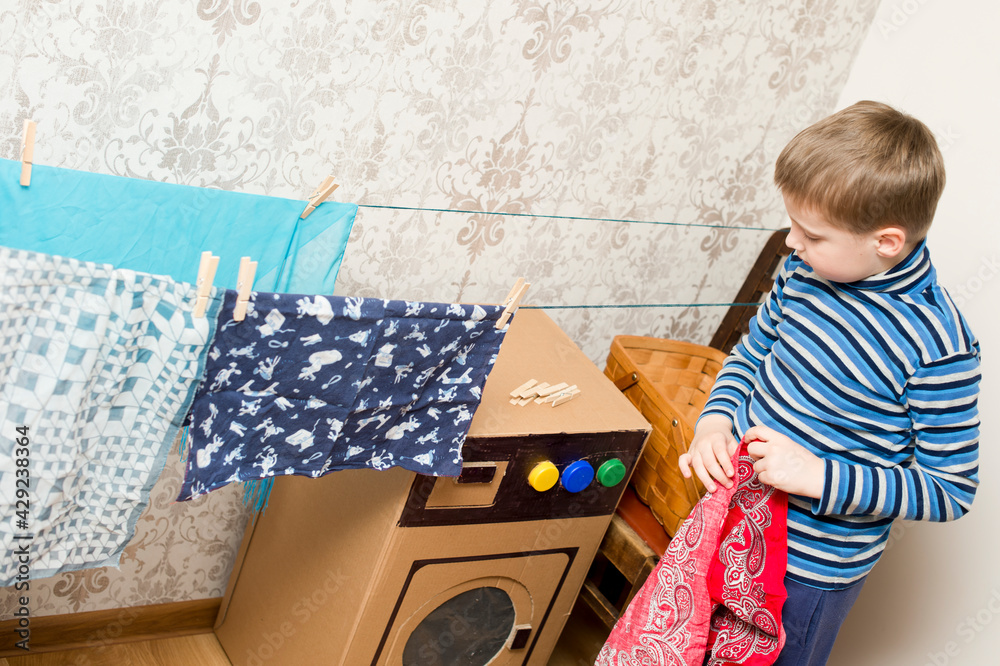 laundry service. kid doing laundry with homemade corrugated cardboard ...