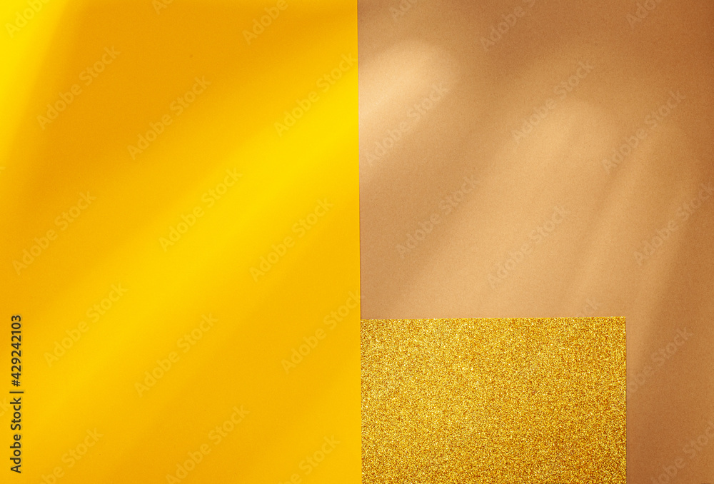 Abstract gold background with sunlight rays and sparkle of gold glitter ...