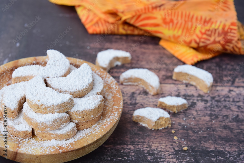 Putri Salju or crescent-shaped cookies coated with powdered sugar ...