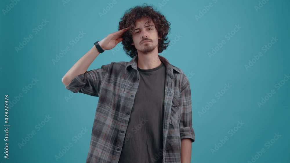 The serious young man puts his hand to his forehead as a sign of ...