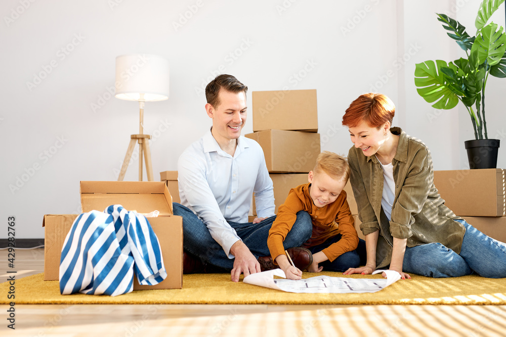 family looking at blueprint planning new home interior design settling ...