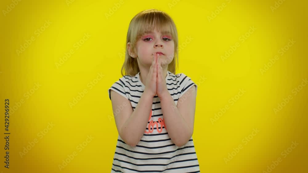 Forgive me. Little blonde teen kid child girl praying, looking upward ...