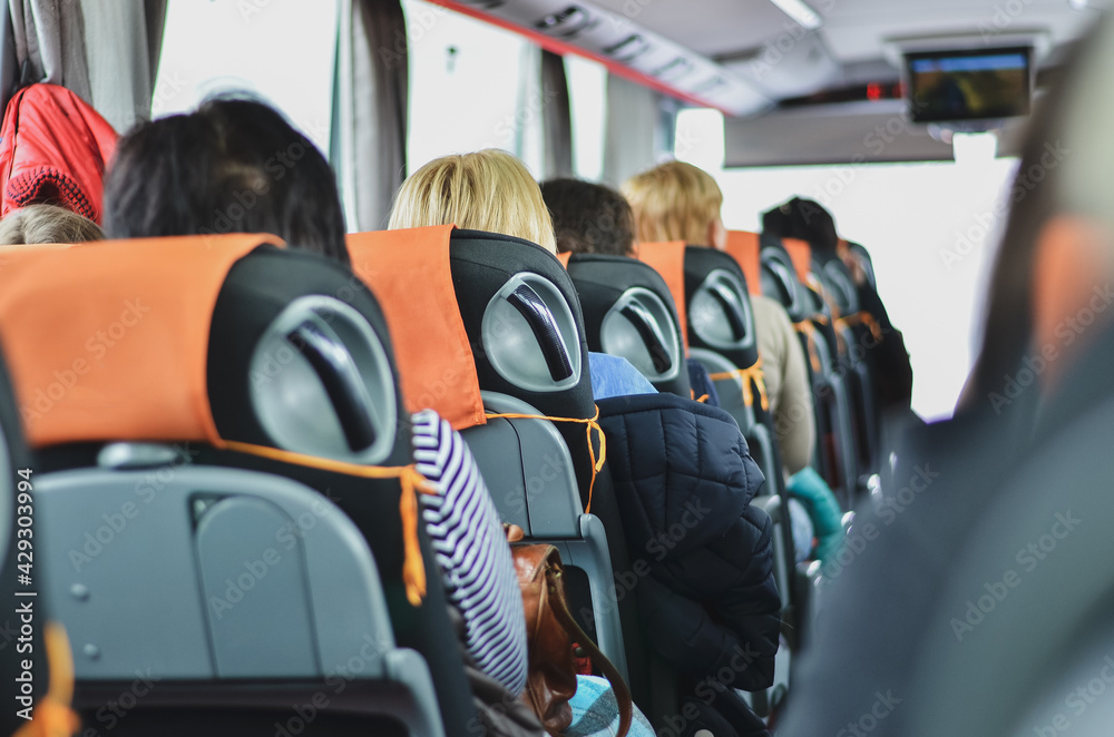 Back view of the tourists travelling in the intercity bus. Travel ...