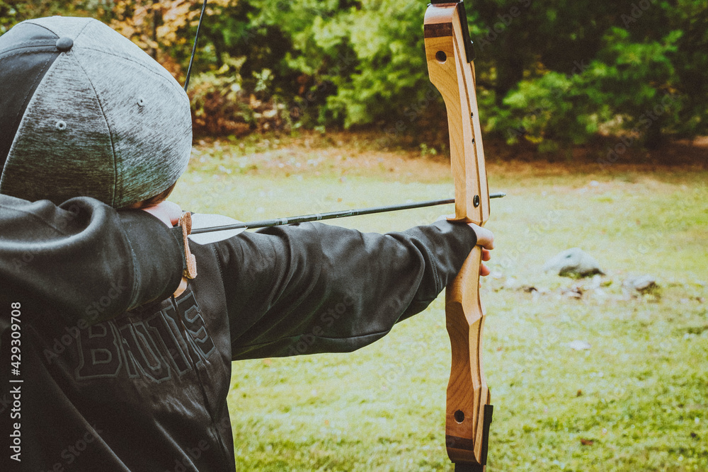Young archer - to use a bow and arrow, aim, vintage color, filtered ...