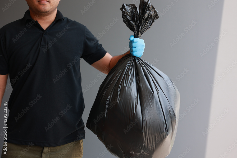 The young man separated the dangerous waste into a large black bag and ...