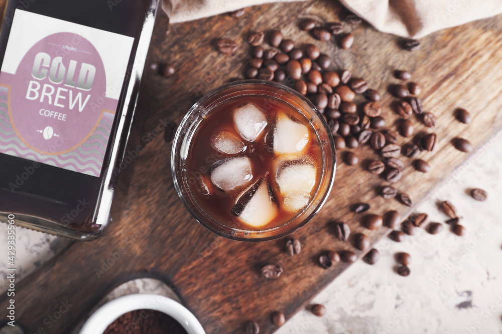 Composition with tasty cold brew and coffee beans on grunge background ...