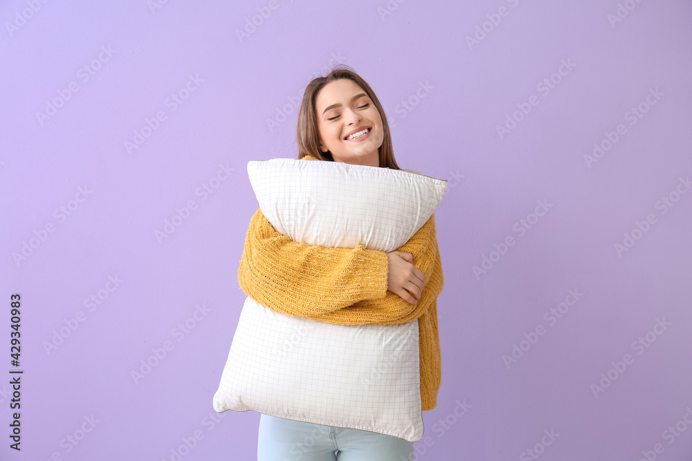 Beautiful young woman with soft pillow on color background Stock Photo ...