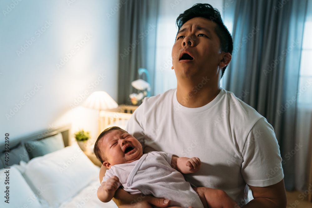 portrait overwhelmed asian father is holding his crying baby daughter ...