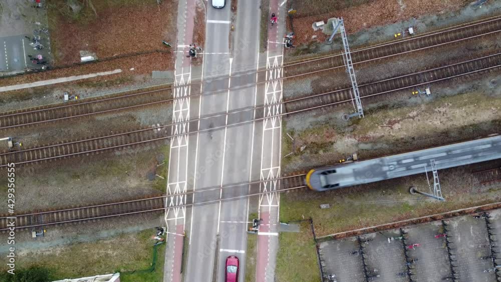 Aerial top down view of level crossing high speed train passing over ...