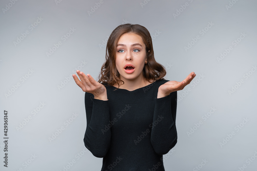 Confused young brunette woman student shrugging shoulders, not know ...