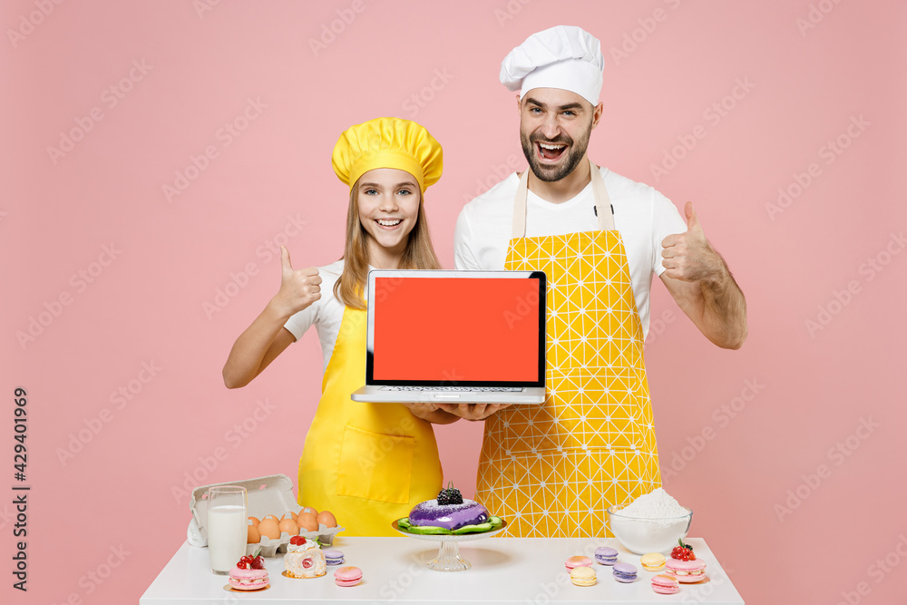 Teen girl dad chef cook confectioner baker in yellow apron cap at table ...