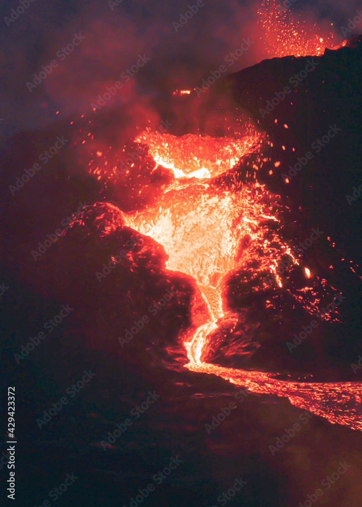 Lava exploding in from the volcano with lava floating down, night in ...