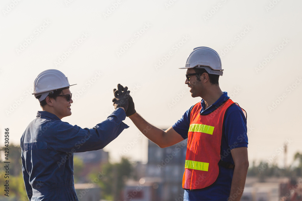Foto de Engineer and worker soul brother handshake, thumb clasp ...