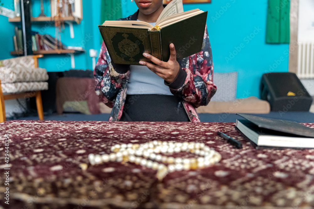 Black Muslim woman studying and reading Stock Photo | Adobe Stock