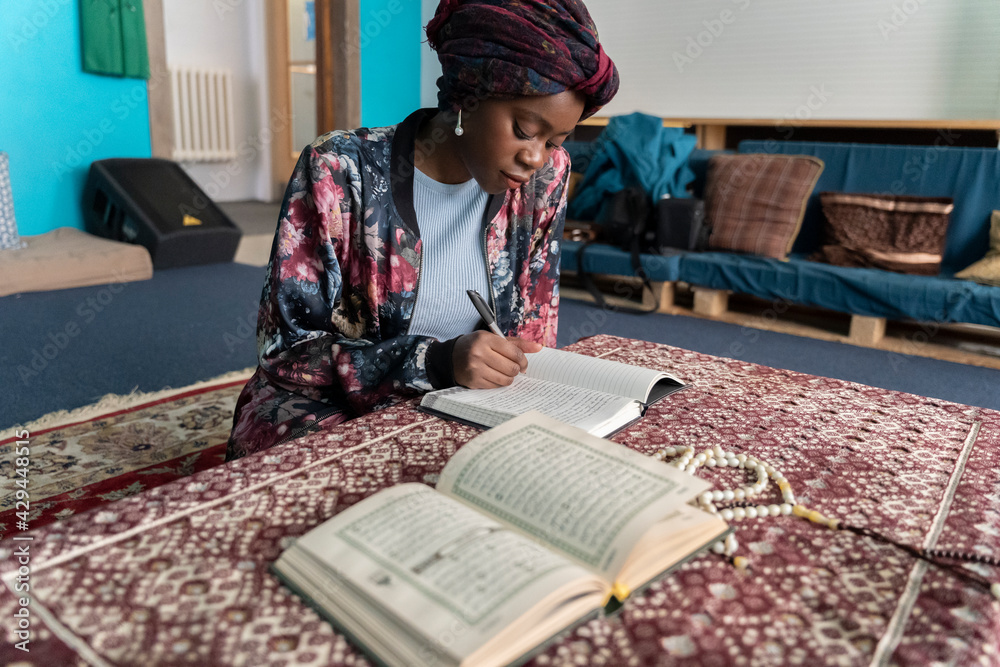 Black Muslim woman studying and reading Stock Photo | Adobe Stock