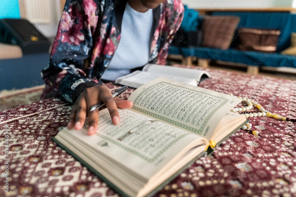 Black Muslim woman studying and reading Stock Photo | Adobe Stock