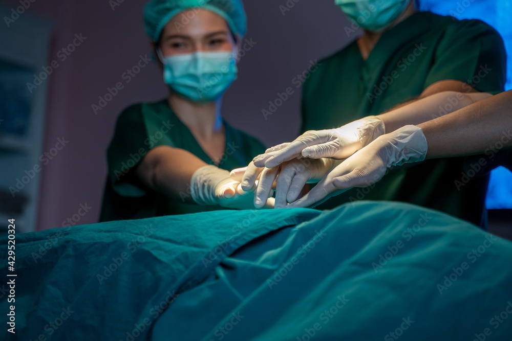 Team surgeons success putting and joining their hands teamwork together ...