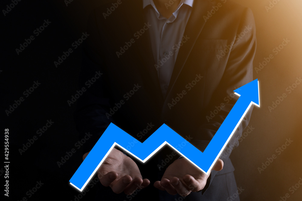 Businessman man holding a graph with positive profits growth. plan ...
