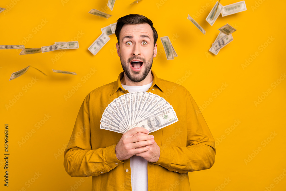 Photo of cute impressed young gentleman dressed casual outfit holding ...