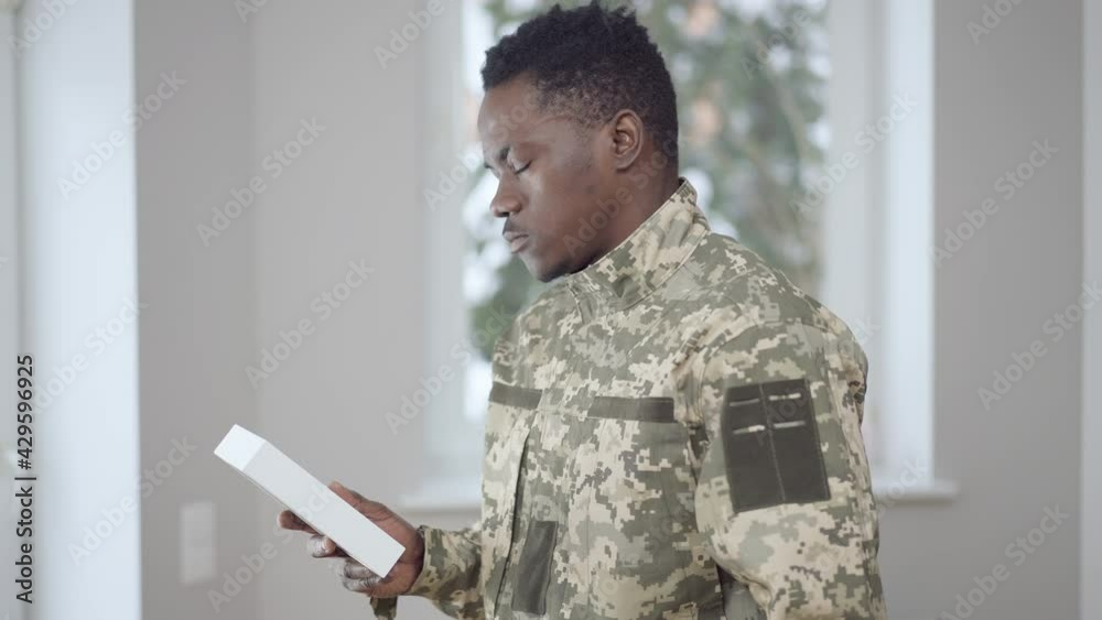 Side view portrait of upset young African American military man looking ...