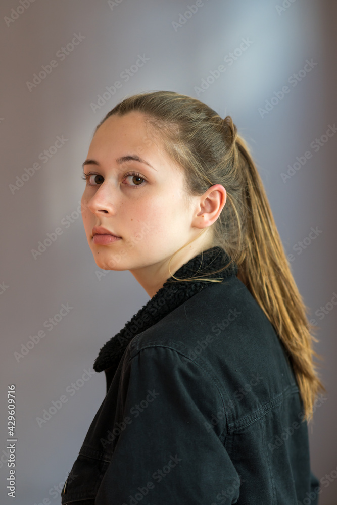 Three quarters shot or semi profile portrait of a pretty teenage girl ...