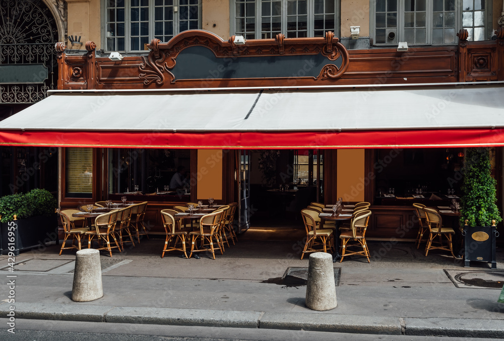 Typical view of the Parisian street with tables with tables of cafe in ...