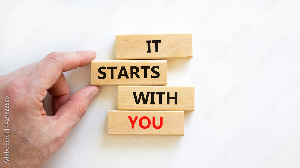 It starts with you symbol. Wooden blocks with words 'it starts with you ...