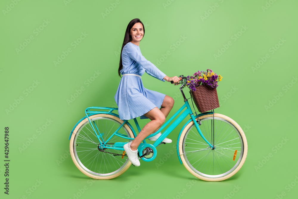 Full length profile photo of positive brown hair lady ride bicycle wear ...