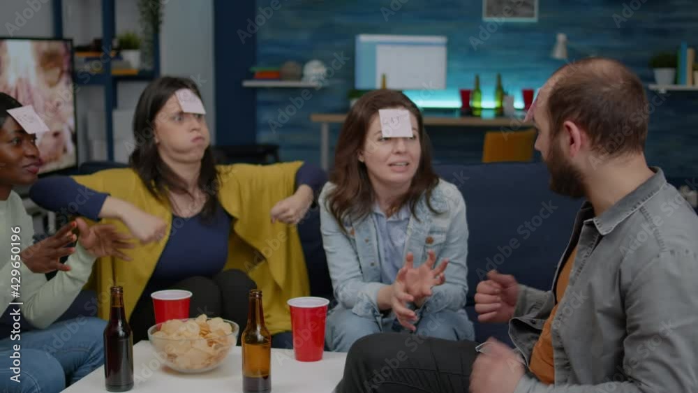 Mixed race friends socializing during creative party while playing ...