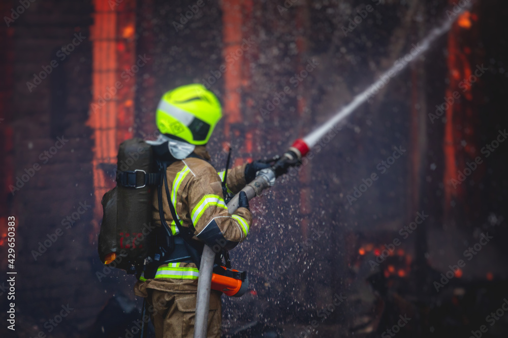 Firefighters put out large massive fire blaze, group of fire men in ...