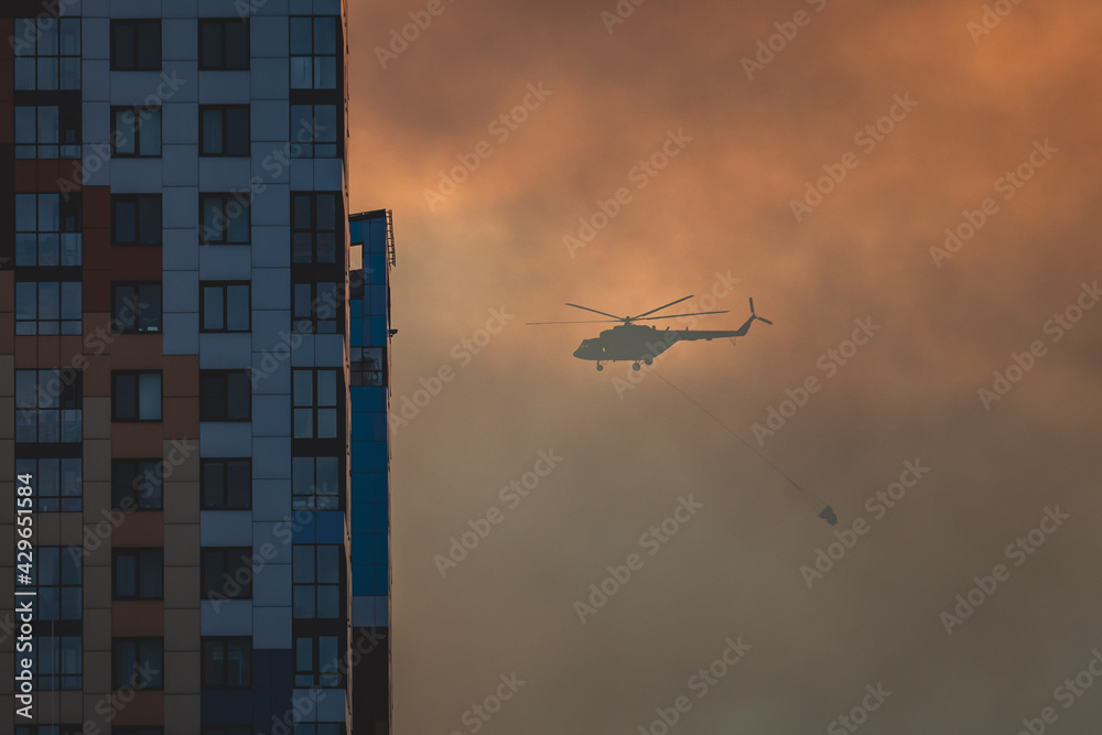 Fire fighting helicopter silhouette with bambi bucket for сarrying ...