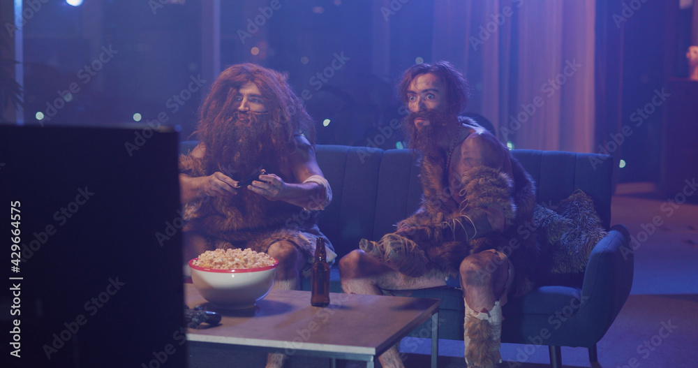 Humor concept. Ancient homo sapiens couple of cavemen in savage animal ...