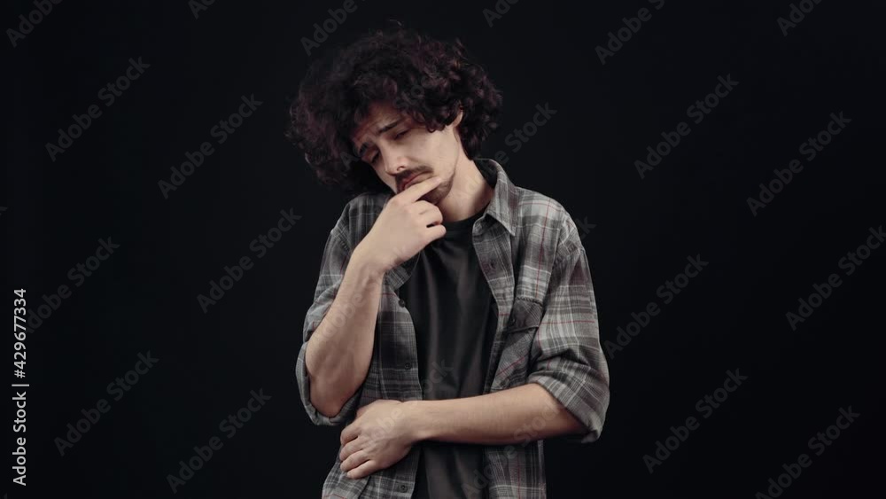 The charismatic young man raises his shoulders and hands in a sign of ... The charismatic young man raises his shoulders and hands in a sign of ...
