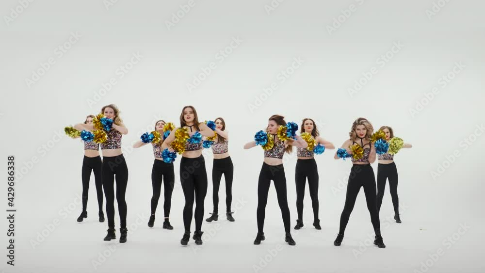 Group of athletic cheerleaders in silver tops and black tight leggings ...