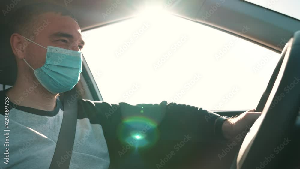 Stockvideon delivery service. worker driver in mask in a sunlight the ...