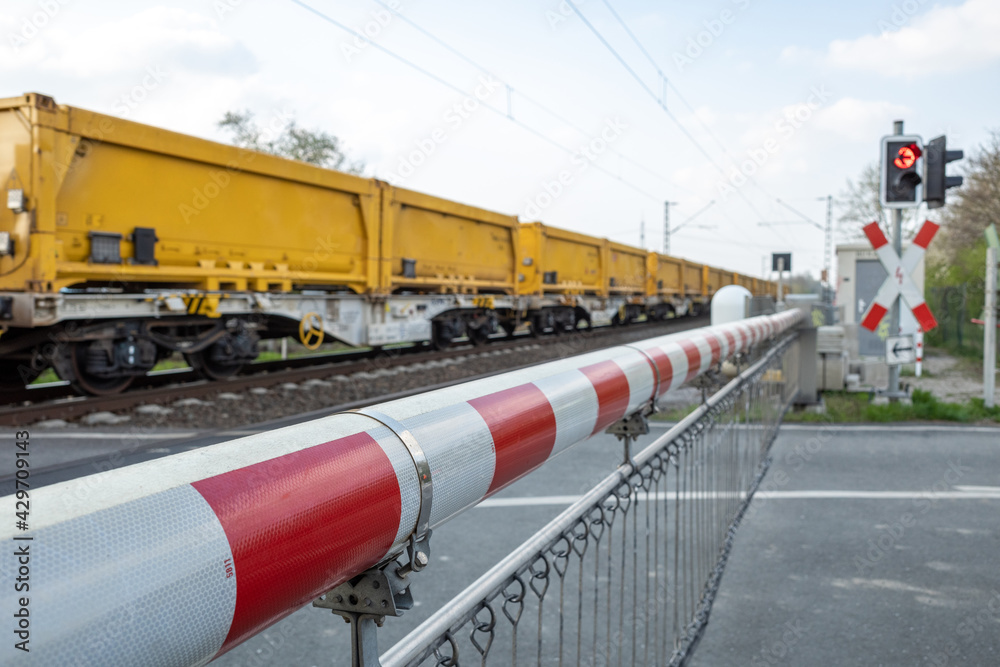 Selective focus view at red and white level crossing railway barrier ...