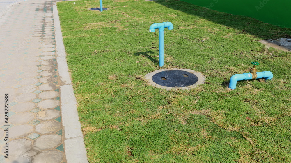 Septic tank and ventilation ducts. Metal cover with pipes and valves of ...