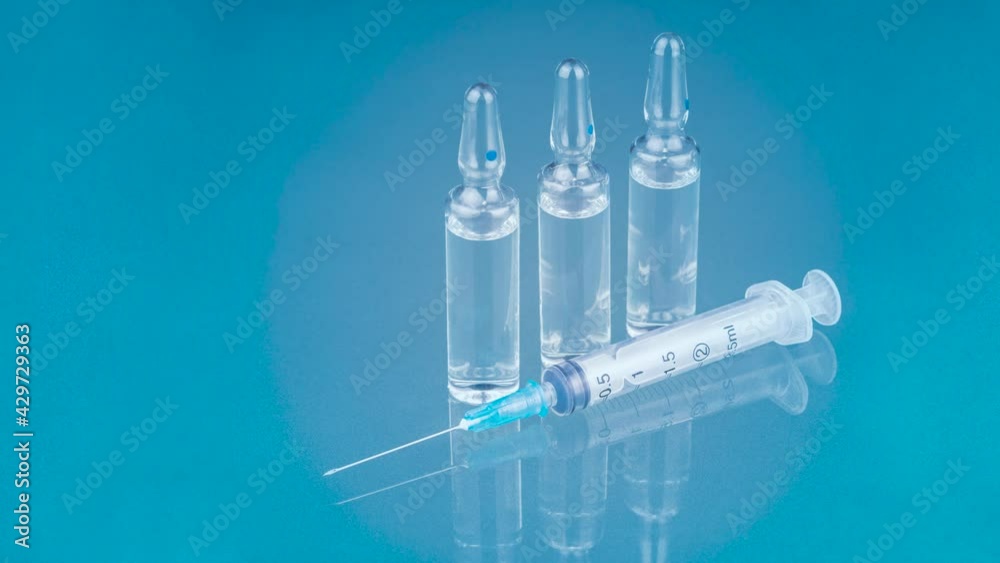 Vials of medicine and syringe. Close up: syringe and injectable drugs ...