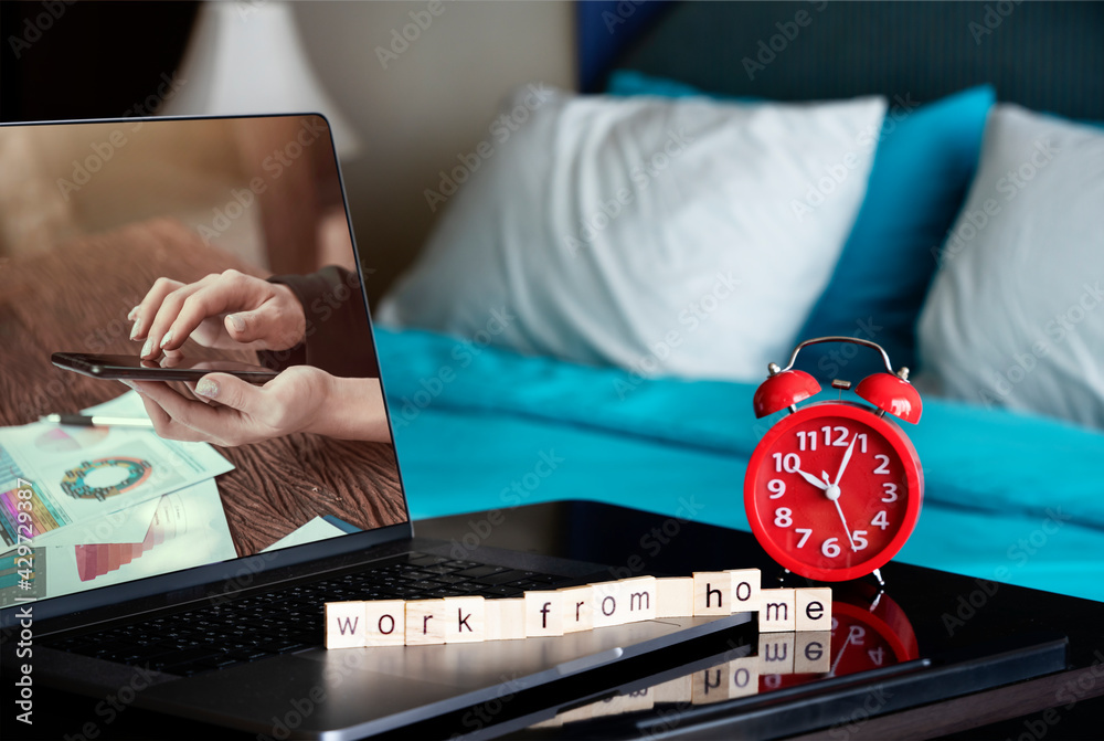 Work from home. Laptop with WFH wording and red Alarm clock 10 O'clock ...