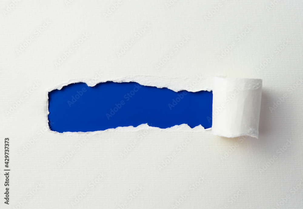 torn paper with the curled ripped sides. a long blue hole of torn on ...