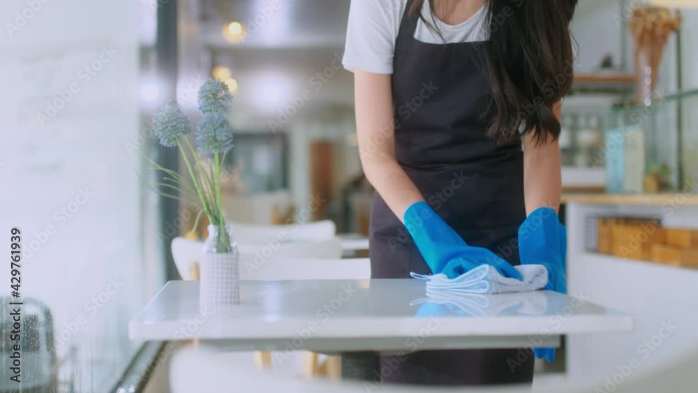 Close-up.Asian female worker clean the table is disinfected by ...