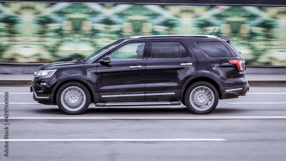 Fast moving black Ford Explorer U502 facelift on highway road ...
