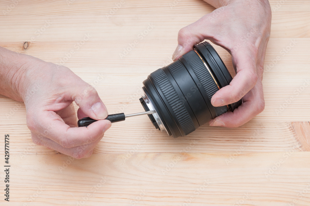 Manual repair process of camera lens on wooden background Stock Photo ...
