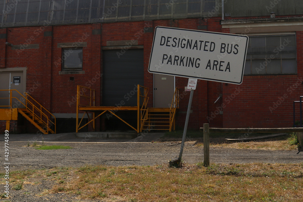 black and white Designated Bus Parking Area sign on a metal pole Stock ...