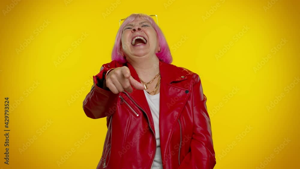 Elderly amused granny woman pointing finger to camera, laughing out ...